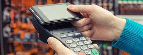 Premium Photo Payment Terminal With Mobile Phone Using For Cashless Paying For Shopping In