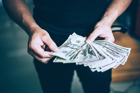Premium Photo Midsection Of Man Holding Paper Currency
