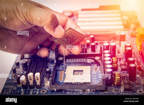 Center Of CPU Macro Photography Of Cpu Unit Man Fixing Computer By Putting CPU On Socket Stock