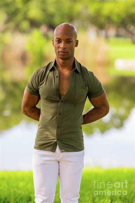 Photo Of A Handsome Black Male Model Posing Ith Arms Behind His