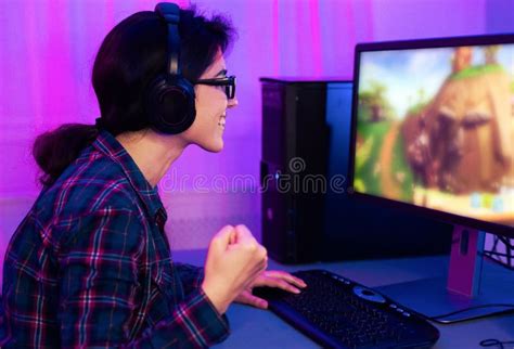 Woman Gaming In A Purple Room With A Computer Monitor Stock Image