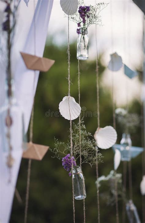 Wedding Decor Bottles With Flowers And Shell Mobile On Green
