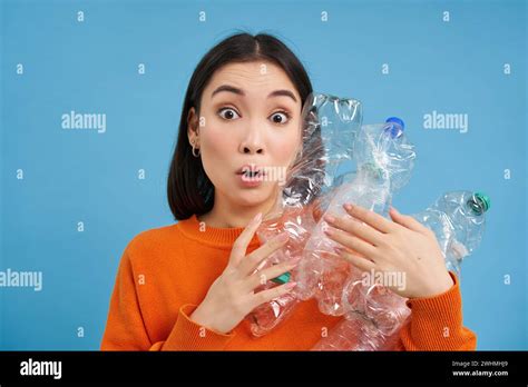 Portrait Of Cute Korean Woman Holding Two Plastic Bottles With Excited