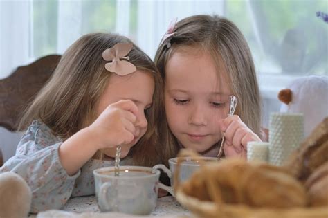 Premium Photo Two Young Sisters Enjoying A Vintagestyle Tea Party