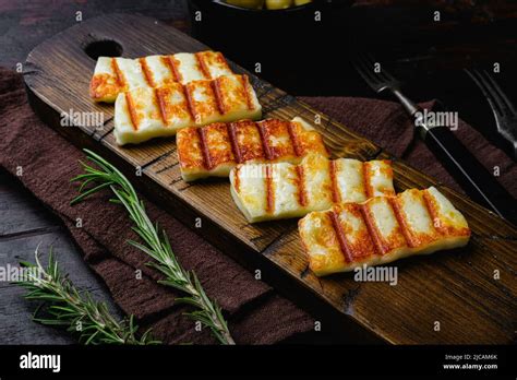 Grilling Halloumi Cheese On Old Dark Wooden Table Background Stock