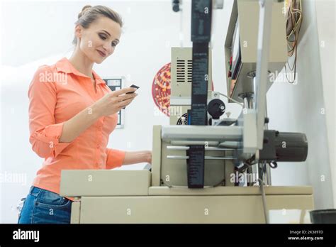 Worker Checking Textile Label Fresh From The Printing Machine Stock