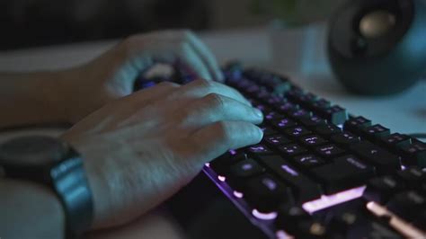 Close Up Of Male Hands Typing On Glowing Keyboard Clip Man Is Typing On Professional Backlit