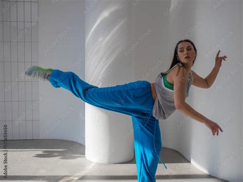 Modern Dance Stylish Young Brunette In Baggy Blue Pants Dancing In