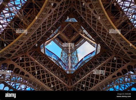 eiffel tower from below looking up through its intricate metal