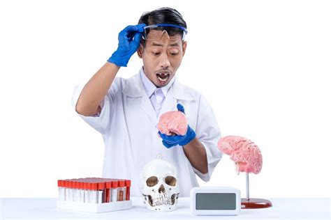 Premium Photo Asian Nerd Scientist Standing And Holding A Human Brain