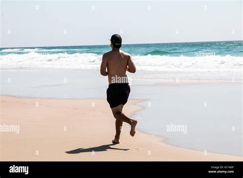 Man Running Along Beach On The Gold Coast In Queensland Australia Stock Photo Alamy