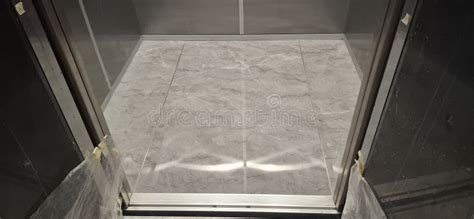 Modern Elevator Interior With Grey Marble Flooring And Stainless Steel