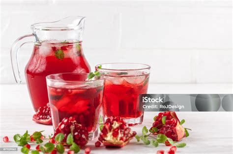 석류 아이스와 아름 다운 유리 및 용기 신선한 익은 석류 흰색 나무 바탕에 민트 칵테일 달콤한 레드 주스입니다 사진을 닫습니다 선택적 초점 0명에 대한 스톡 사진 및 기타