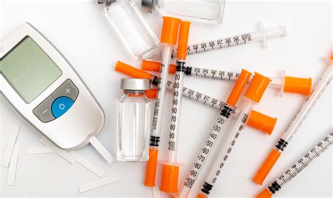 Premium Photo Glucometer And Insulin Syringe Lancing Device Tester Strip On White Background