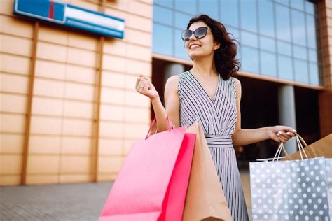Premium Photo Shopping Time Young Woman With Shopping Bags Near The