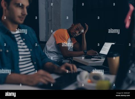 Selective Focus Of African American Programmer Looking At Multicultural