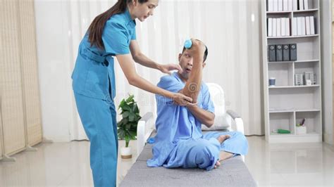 A Nurse Helps With Physical Therapy For A Male Patient At The Hospital Asian Male Patient