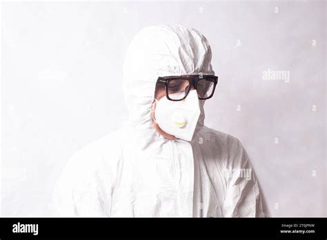 Doctor Scientist In White Coverall Suit Mask And Glasses Dispersal