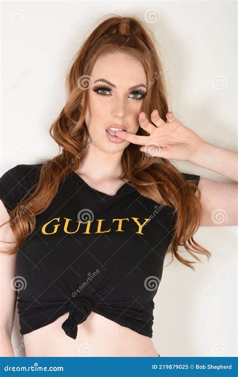 Beautiful Tall Slim Redhead Model In A Fashionable T Shirt And Black Jeans Stock Image