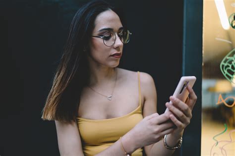 4g 무선 연결로 스마트폰 기기를 이용해 소셜 네트워크에서 콘텐츠 게재를 공유하기 위한 텍스트 입력 밀레니얼 블로거 안경을 쓴 코카이산 힙스터 소녀 25 29세에 대한 스톡