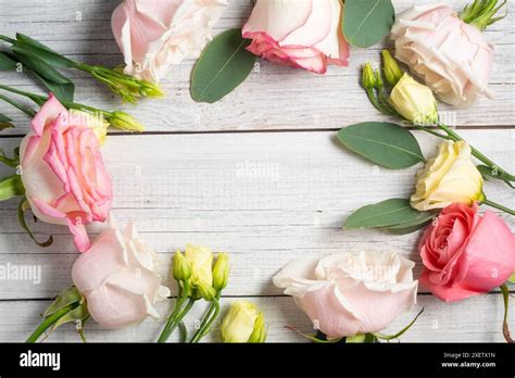 Floral Frame On A White Wooden Shabby Background Creamy Eustoma Eucalyptus And Pink Roses