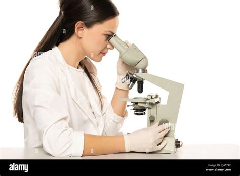 Female Scientist Looking Through A Microscope White Background Stock