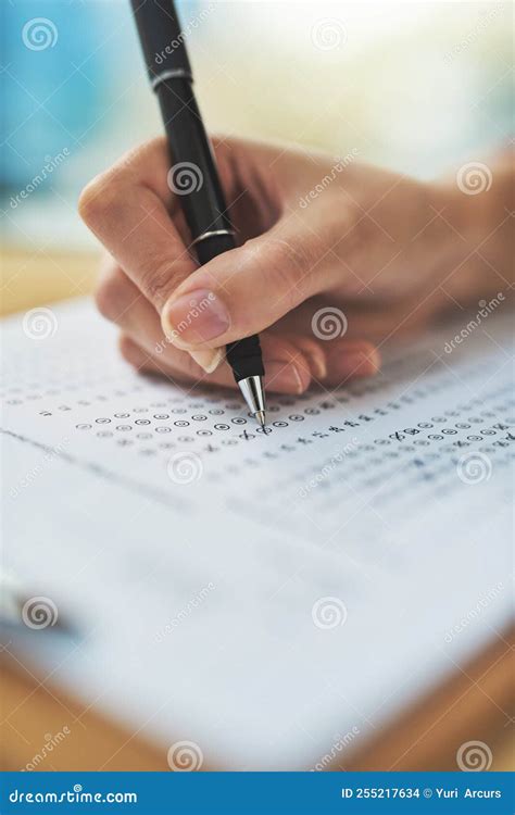 Hoping To Pass This Test A Woman Filling In An Answer Sheet For A Test