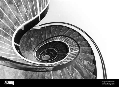 Sprial Staircase Forming A Beautiful Shell Pattern With White Wall For