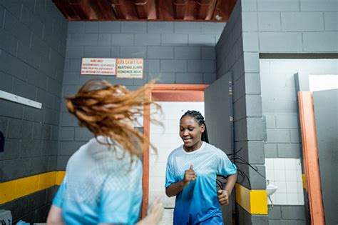 female soccer players doing warm up exercises in the locker room stock