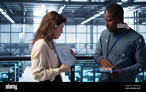 Team Of It Professionals Looking Over Data Center Checkup Checklist