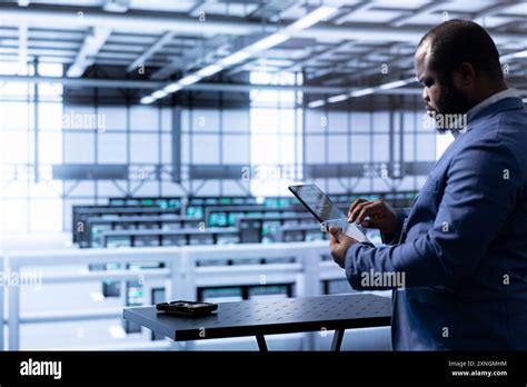 Engineer In Data Center Using Tablet To Identify And Solve Technical