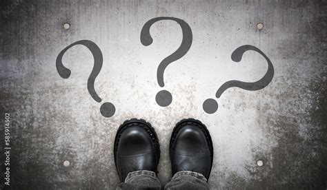 heavy black leather boots and three question marks problem concept