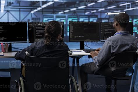 Person With Paraplegia And Colleague Working In Inclusive Server Hub