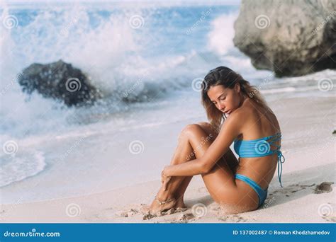 Girl In Blue Swimsuit Posing On Sunny Day On Sandy Beach Stock Image