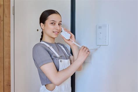 Premium Photo Teenage Girl Holding Intercom Handset While Talking To