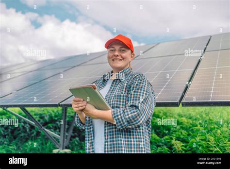 Inspector Engineer Woman Holding Digital Tablet Working In Solar Panels