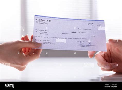 Close Up Of Woman S Hand Holding Cheque And Giving To Man Stock Photo Alamy