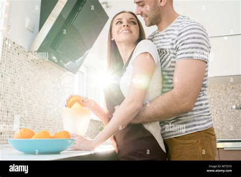 Young woman squeezing boyfriend hi-res stock photography and images - Alamy