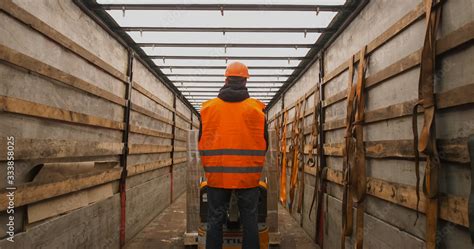 Warehouse Worker Driver In Uniform Loading Cardboard Boxes By Forklift Stacker Loader Stock