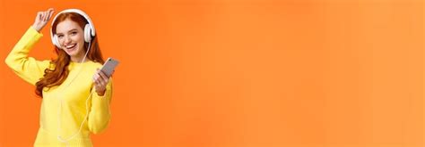 Premium Photo Lets Dance Cheerful Carefree Modern Hipster Girl With Red Curly Hair And