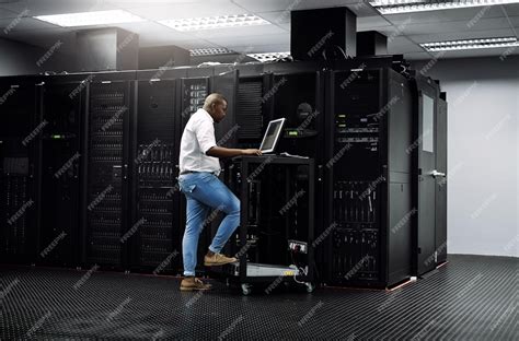 Premium Photo It Support Black Man Or Coding On Computer In Server Room For Big Data Network