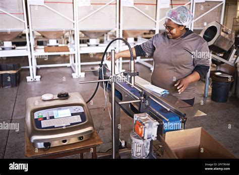 On The Production Line A Woman Working In A Packing And Distribution Warehouse Stock Photo Alamy