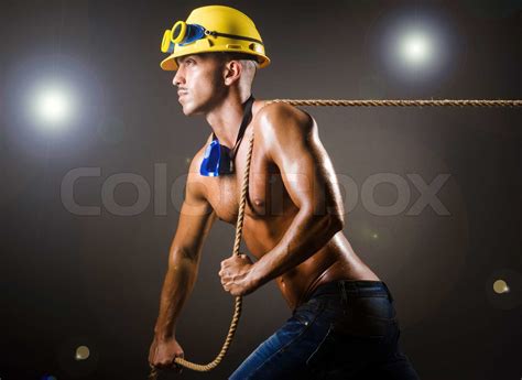 Nude Builder Pulling Rope In Darkness Stock Image Colourbox