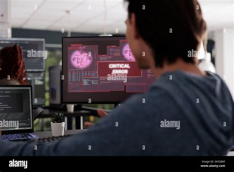 software developer looking at display writing code encountering hacking