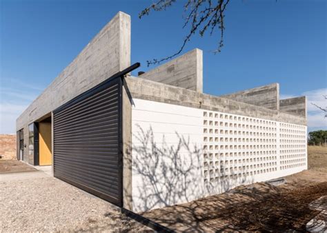 House By Tectum Features Raw Concrete Walls And Black Metal