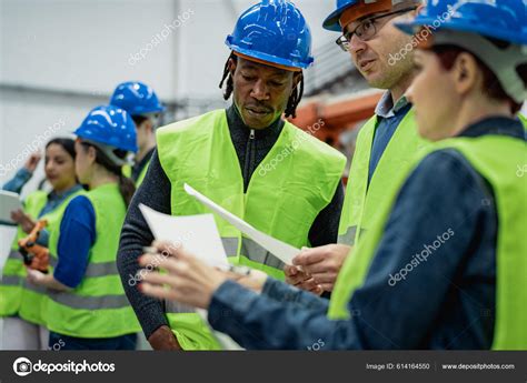 team multiracial engineers working robotic factory tech industry