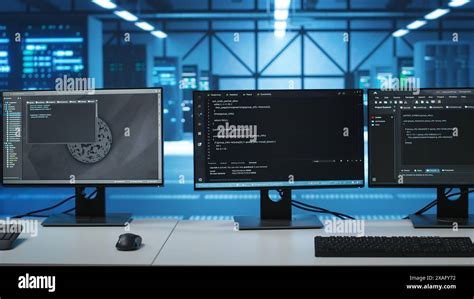 code running on computer screens in empty data center workspace used