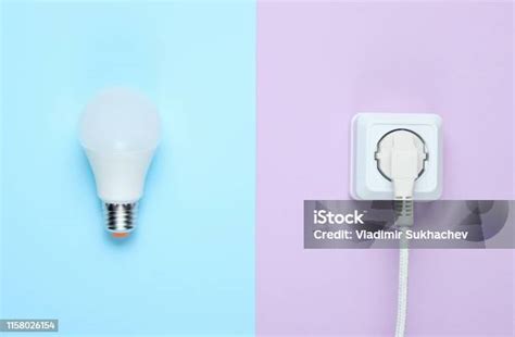 파스텔 배경의 전원 콘센트와 Led 전구에 연결된 흰색 케이블 맨 위 보기 0명에 대한 스톡 사진 및 기타 이미지 0명