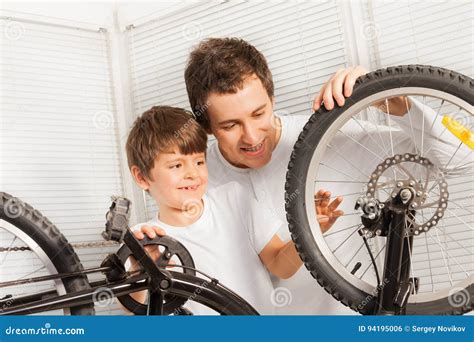 Happy Father And His Son Checking Bicycle Tires Stock Photo Image Of
