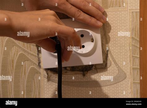 The Hand Includes A Plug In An Old Broken Socket In The Hallway Of The House Socket And Repair
